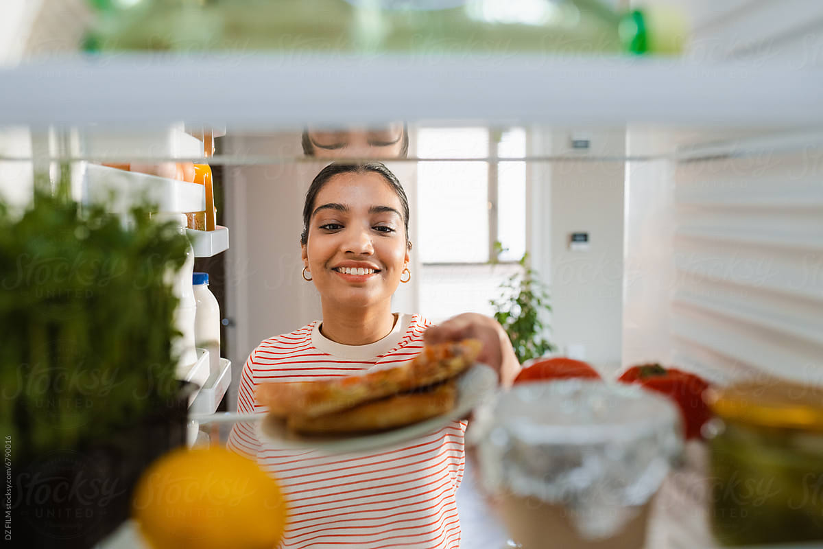 "A Woman Takes Food Out Of The Refrigerator" by Stocksy Contributor "DZ ...