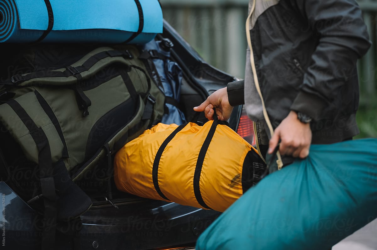 "Man Loading His Car" by Stocksy Contributor "Milles Team" - Stocksy