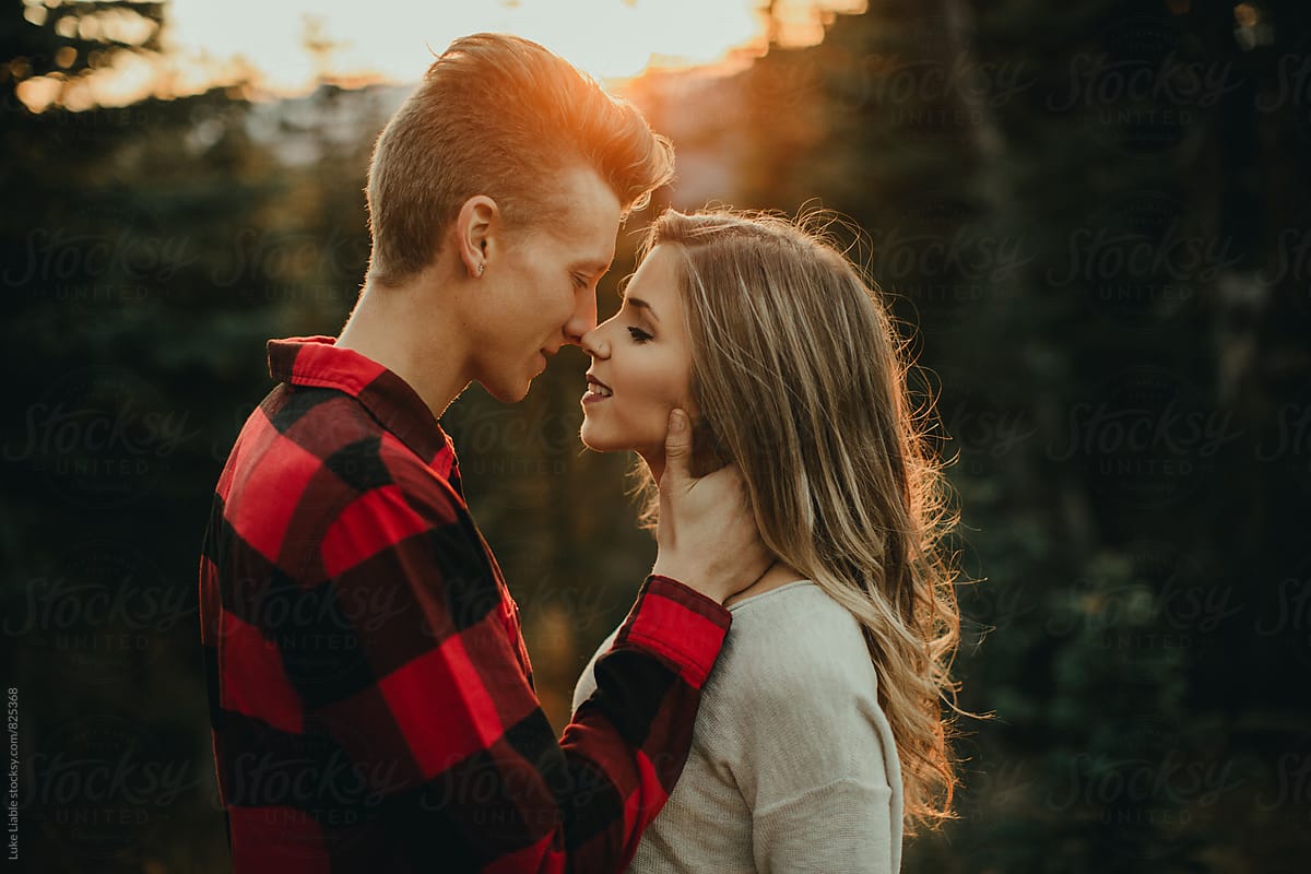"Young Engaged Couple Explore Mountain Side At Sunset" by Stocksy ...