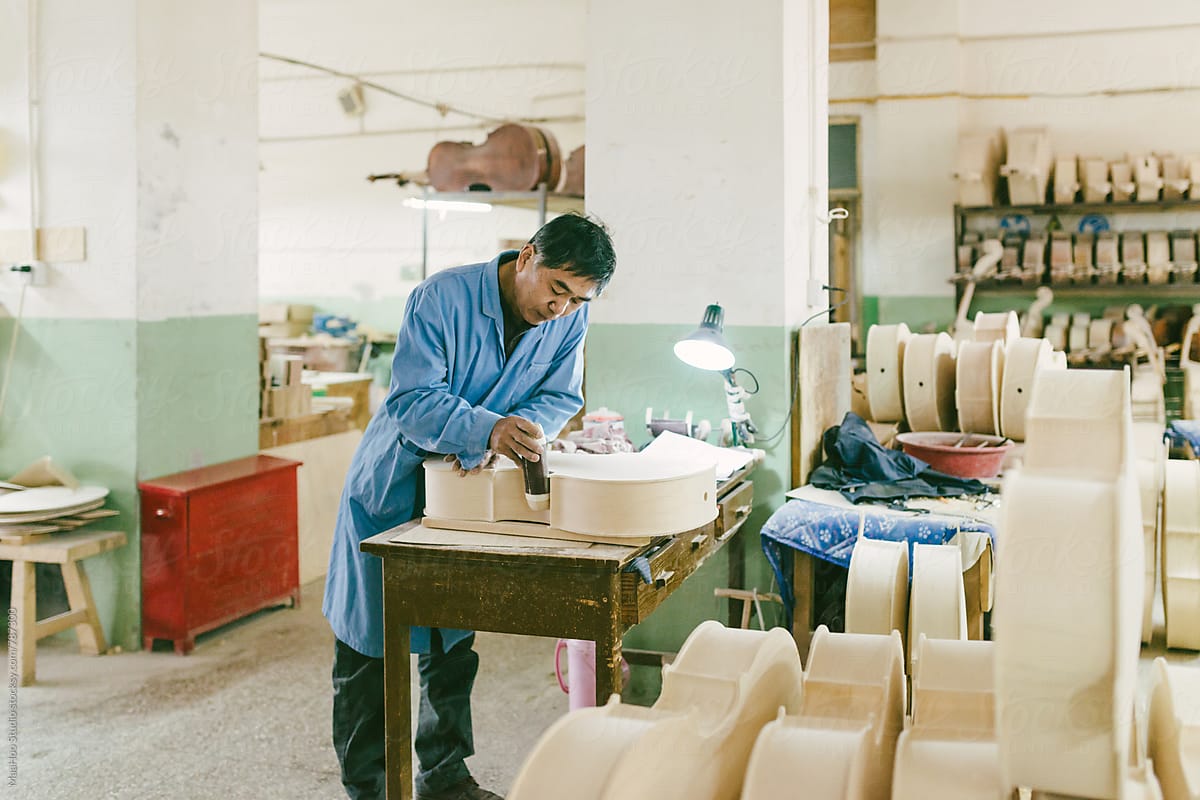 "Violoncello Maker At Work" by Stocksy Contributor "MaaHoo" - Stocksy