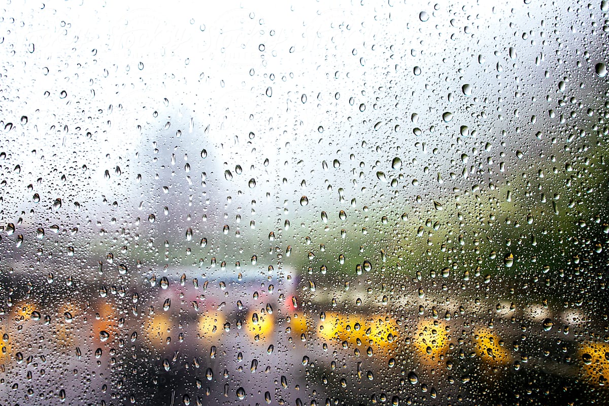 "Raindrops On Bus Windows With A View Of The Parking Lot" by Stocksy ...