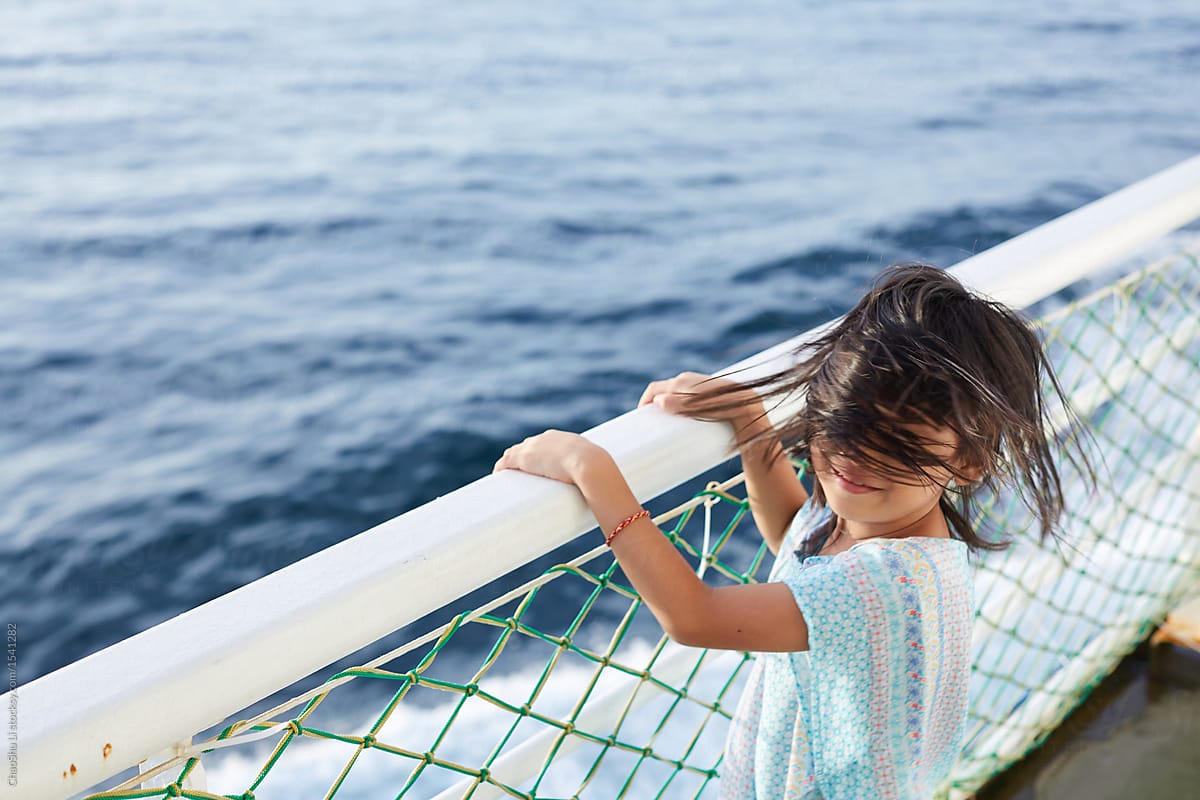 "Asian Little Girl Lying On The Railing. On The Cruise Ship" by Stocksy ...