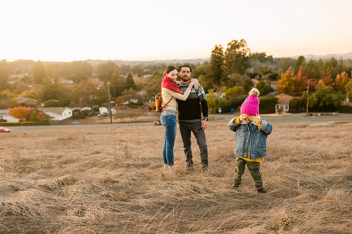 Lovely family enjoying by the field in cold weather - Stock Image ...