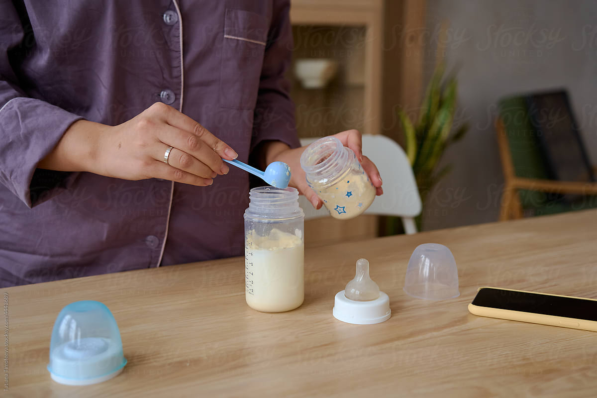 "Mother Mixes Baby Formula" by Stocksy Contributor "Tatiana Timofeeva ...