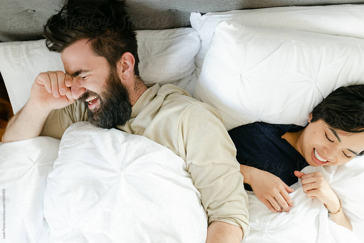 "Happy Couple Laughing In Bed" by Stocksy Contributor "Leah Flores ...