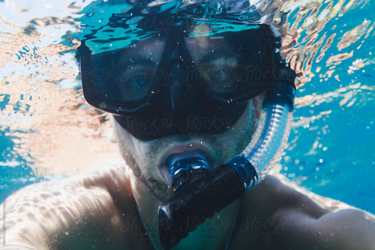 "Man Doing Snorkeling" by Stocksy Contributor "Mauro Grigollo" - Stocksy