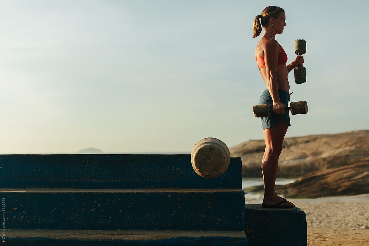 "Strong Woman Exercises On The Beach" by Stocksy Contributor "HOWL ...