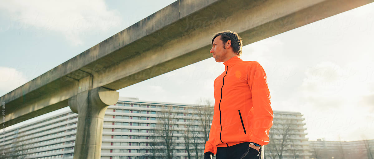 "A Male Athlete Or Runner Standing On A Running Track Looking Around ...