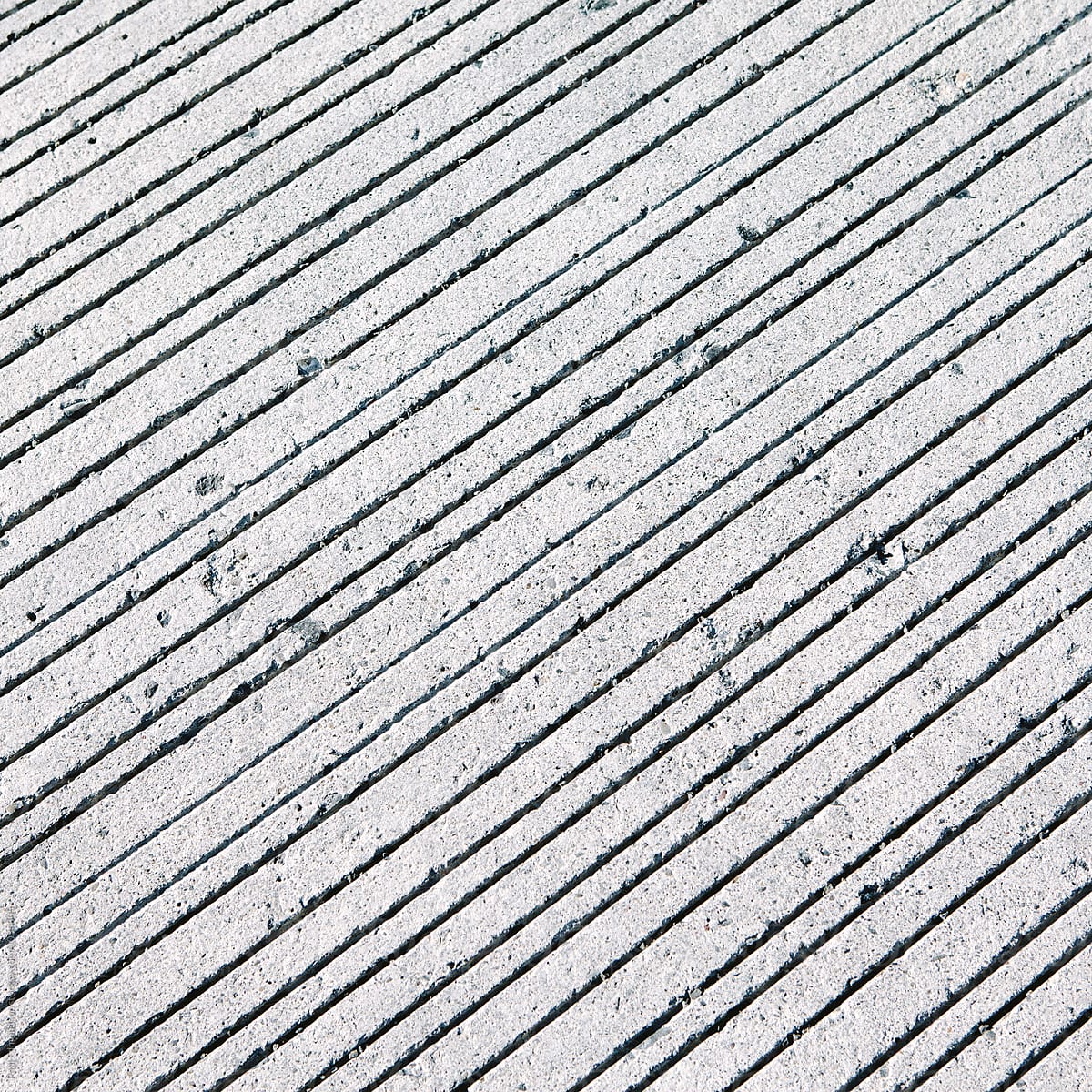 "Close Up Patterns And Traction Lines On Concrete Roadway" by Stocksy ...