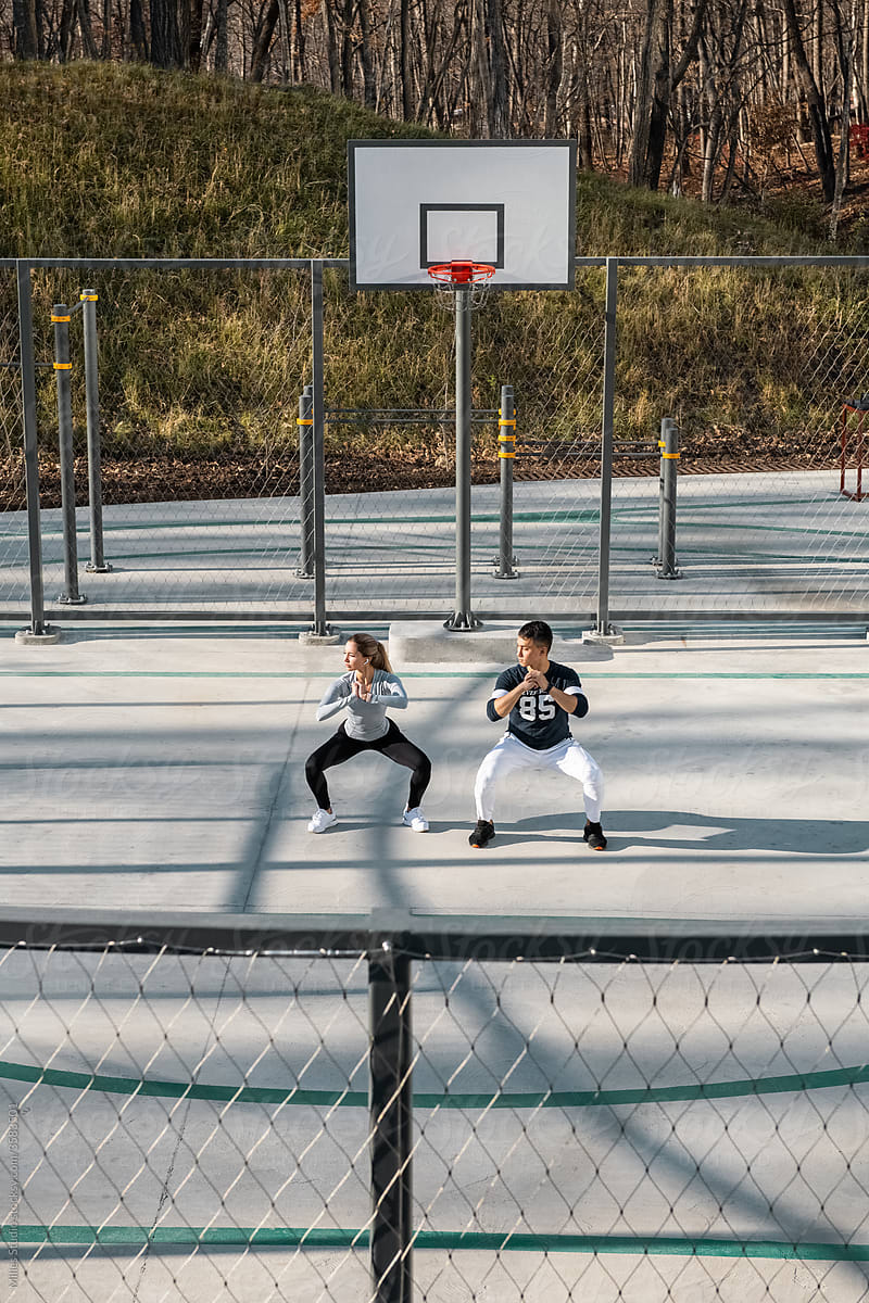 "Man And Woman Squatting On Basketball Court" by Stocksy Contributor ...