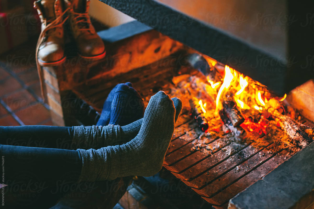"Feet Of A Couple Warming Up By The Fireplace On Winter." by Stocksy ...