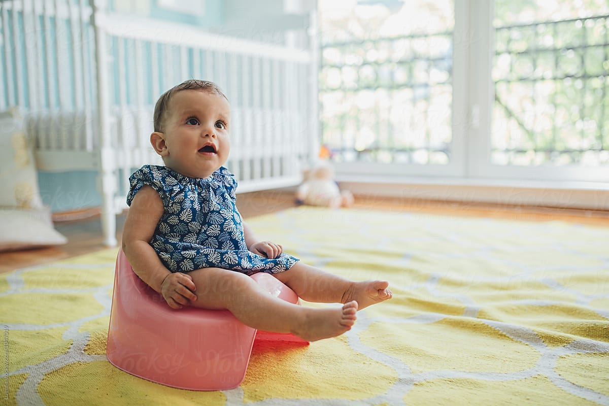 "Baby Girl Sitting On A Potty" by Stocksy Contributor "Lumina" - Stocksy