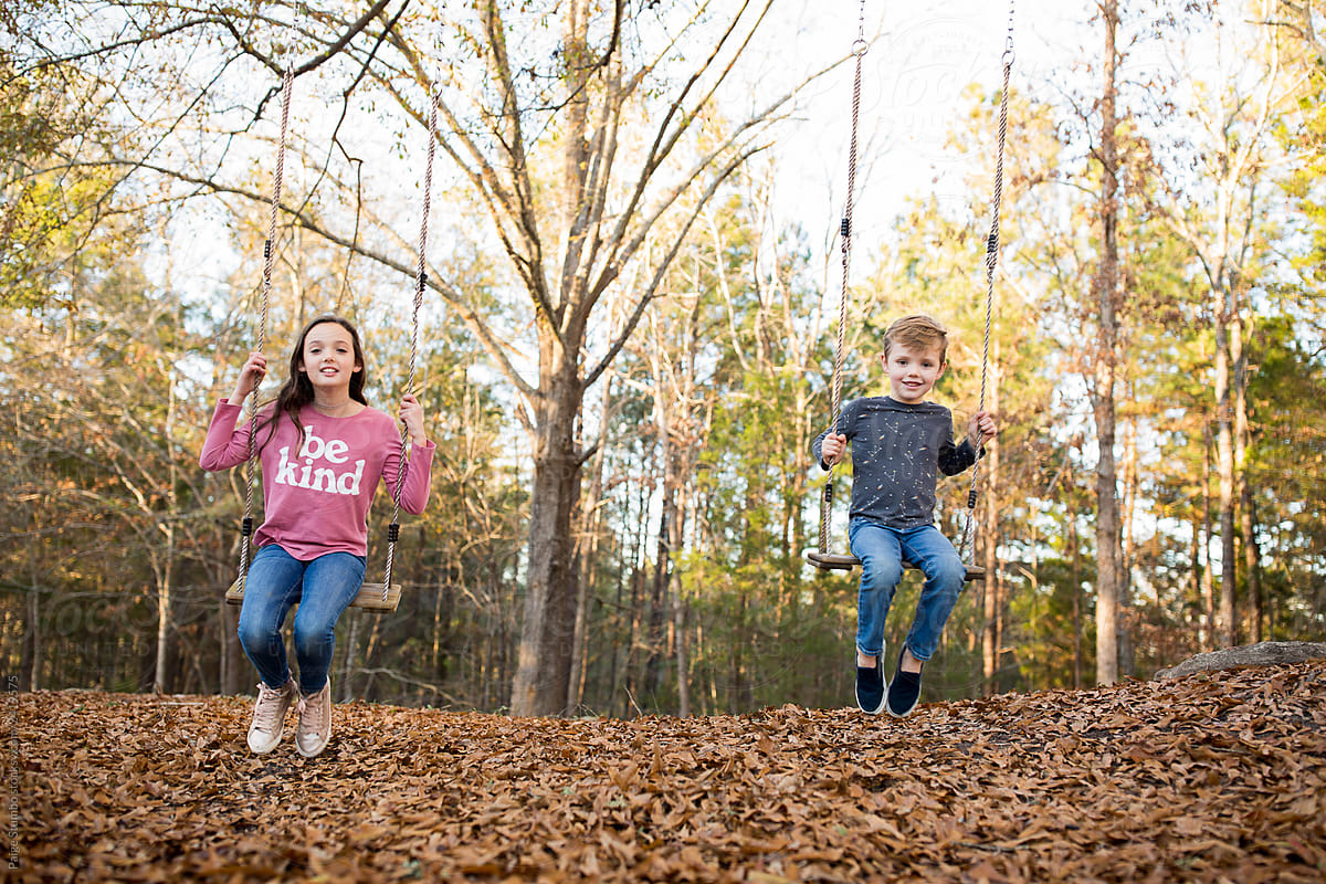 "Happy Kids Swinging" by Stocksy Contributor "Paige Stumbo" - Stocksy