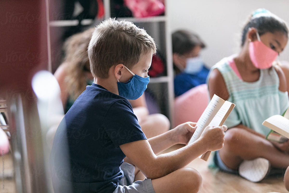 "School: Students Wearing Face Masks Sit On Floor For Reading Tim" by ...