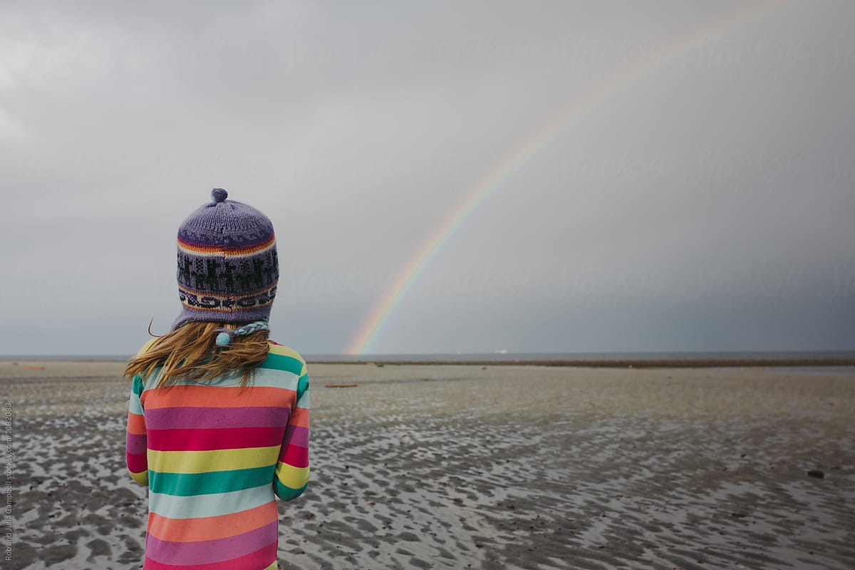 "Young Caucasian Girl Chasing Rainbow On Beach Wearing Pajamas" by ...