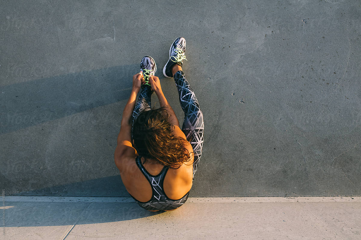 "Overhead Shot Of Jogger Tying Her Shoes" by Stocksy Contributor "Jacob ...