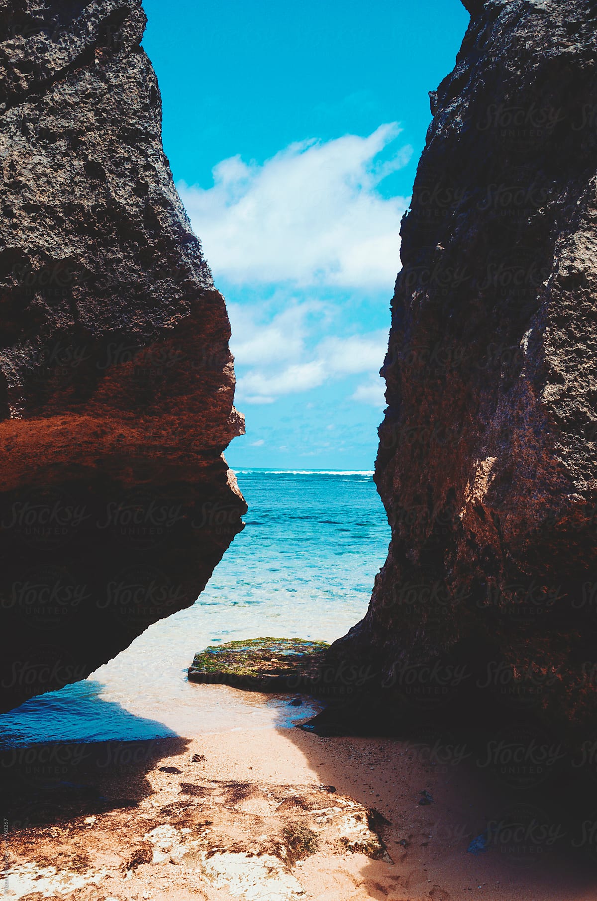 "A Narrow Rock Passage On A Perfect White Sand Small Beach" by Stocksy ...