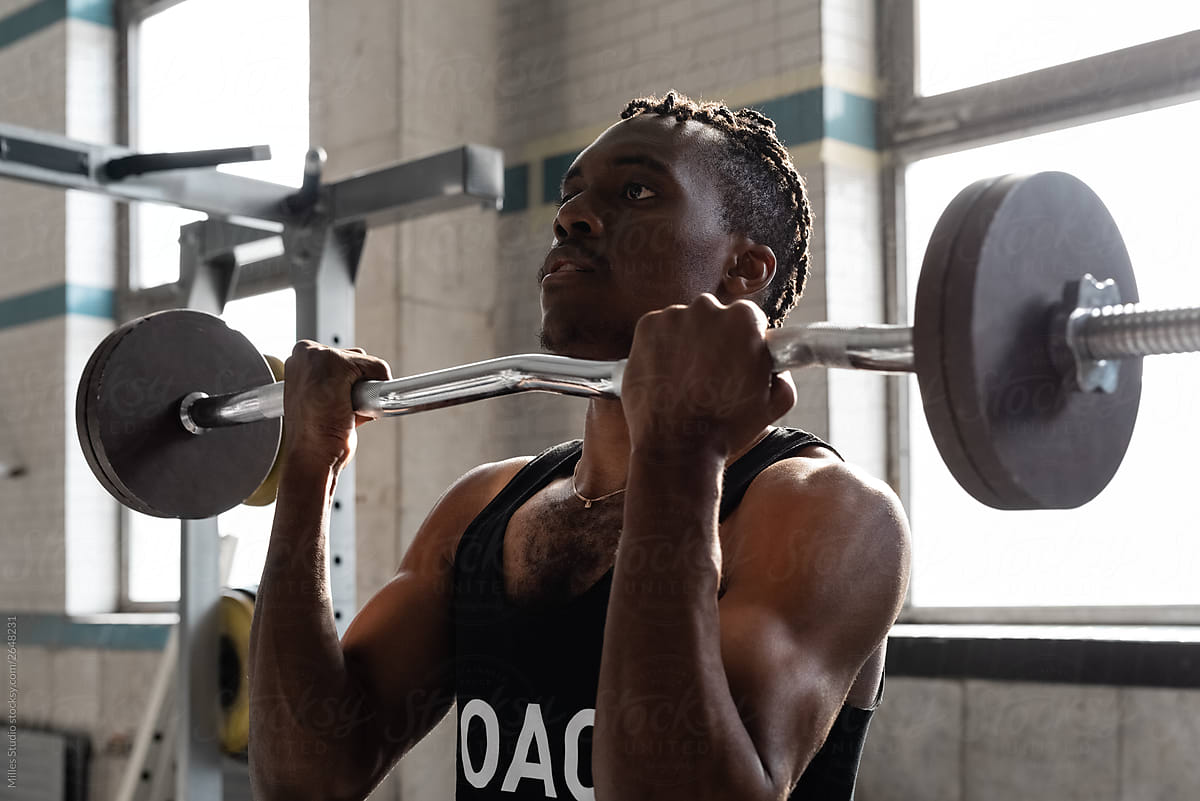 Black man exercising with barbell - Stock Image - Everypixel
