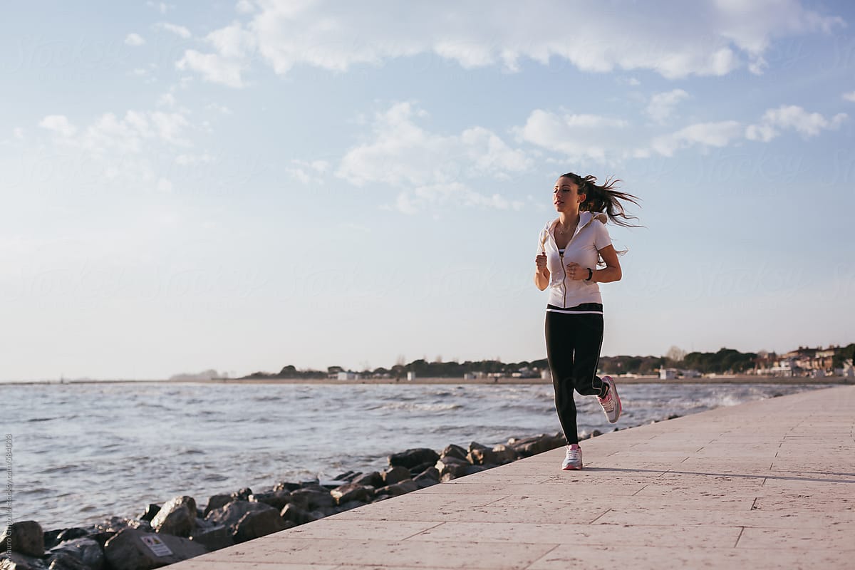"A Woman Runs Outdoor By The Sea" by Stocksy Contributor "Mauro ...