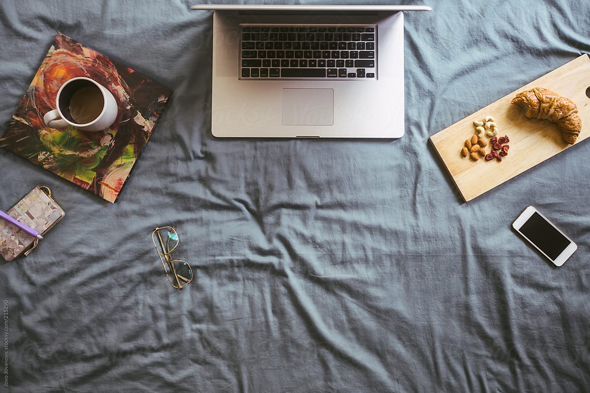 "Getting Ready To Work At Home In Bed With Snacks" by Stocksy ...