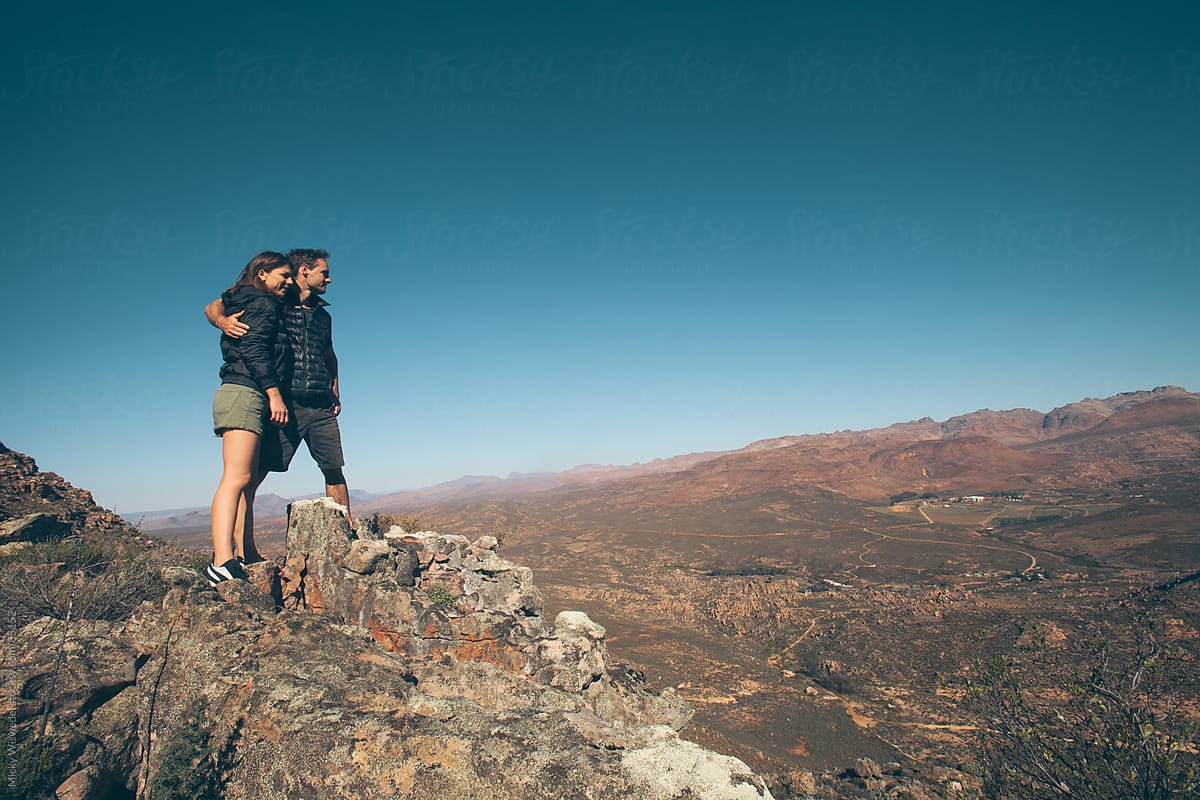 "Hiking Couple At Viewpoint" by Stocksy Contributor "Juno" - Stocksy