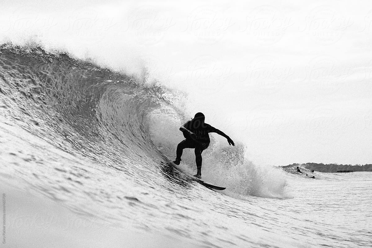 "A Surfer Dropping Down The Face Of A Wave" by Stocksy Contributor ...