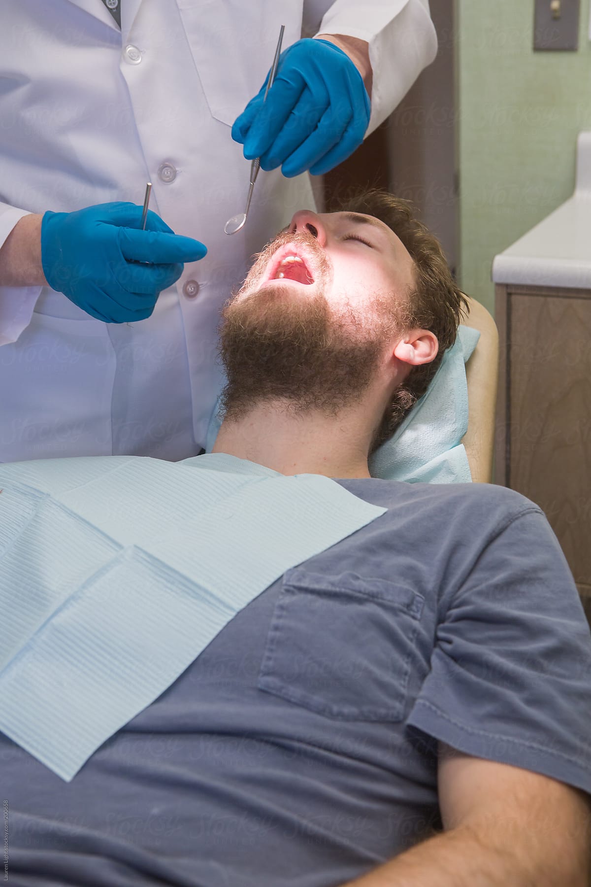 Dentist Working on Man's Teeth - Stock Image - Everypixel