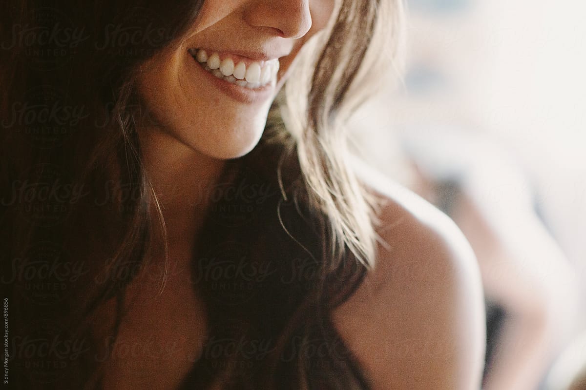 "Young Woman Laughing" by Stocksy Contributor "Sidney Scheinberg" - Stocksy