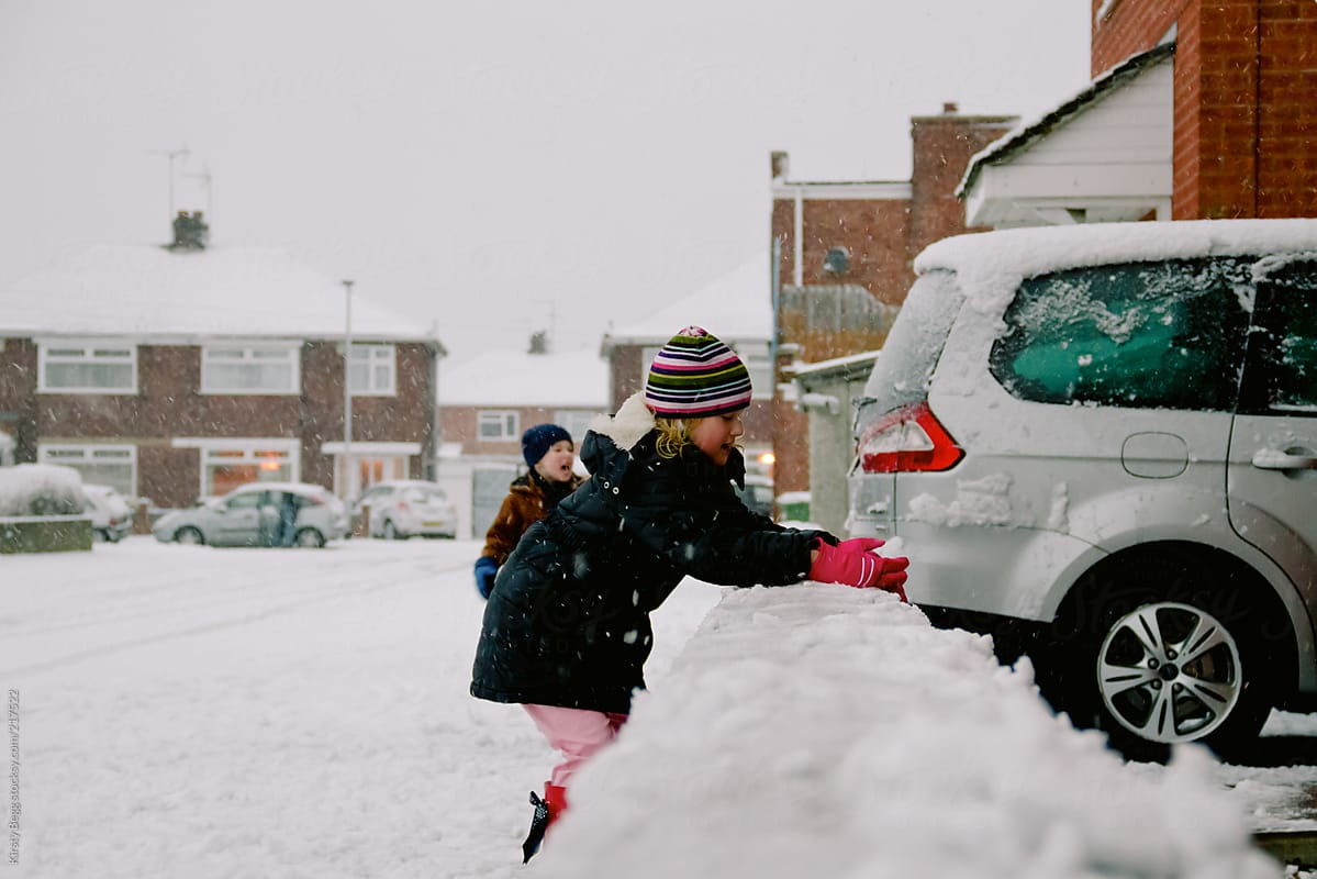 "Children Playing In The Snow At Home" by Stocksy Contributor "Kirsty ...