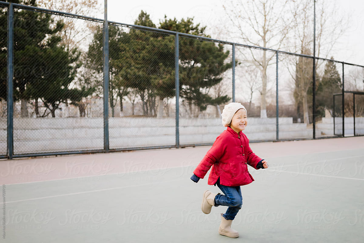 "Little Chinese Girl Running" by Stocksy Contributor "MaaHoo" - Stocksy