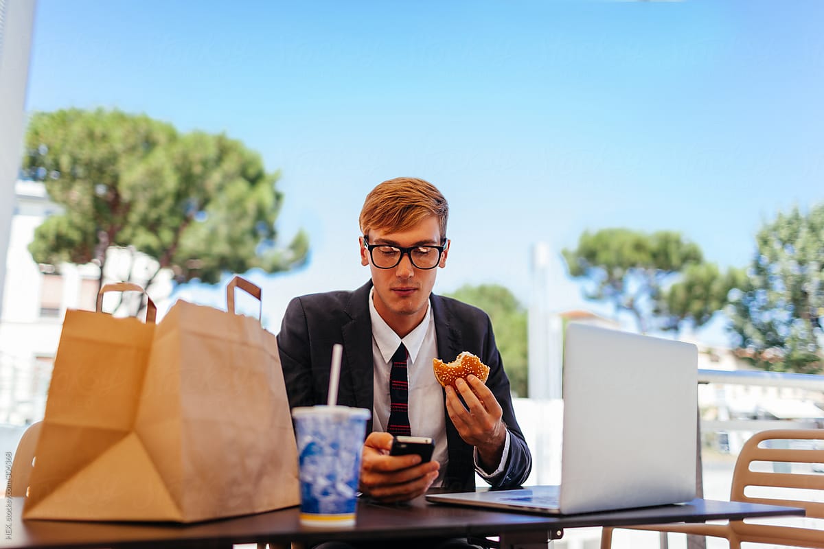 "Businessman Working During Lunch Break" by Stocksy Contributor "Mattia ...