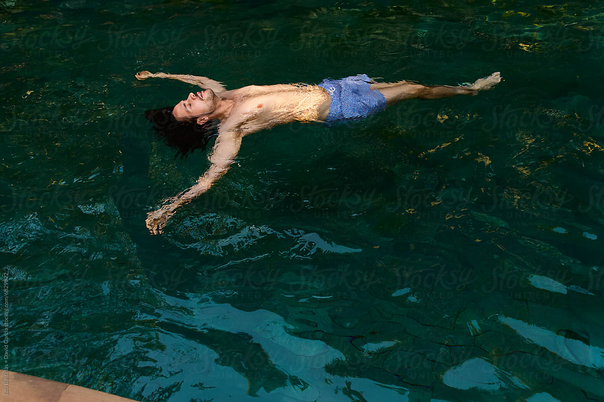 "Man Relaxing And Floating In Clear Pool Water In Siem Reap, Cambodia ...