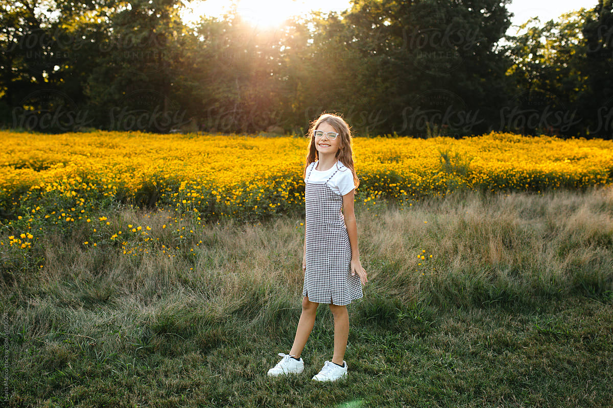 "Preteen Smiles At Camera In Wildflower Field" by Stocksy Contributor ...