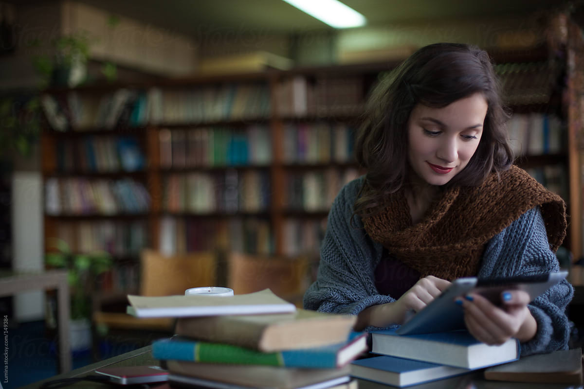 "Woman Using Tablet At The Library" by Stocksy Contributor "Lumina ...