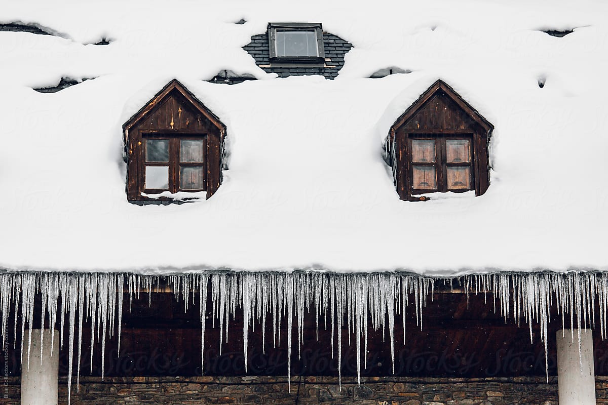 "Facade Of A Mountain Cabin With A Roof Of Large Icicles In The Windows ...