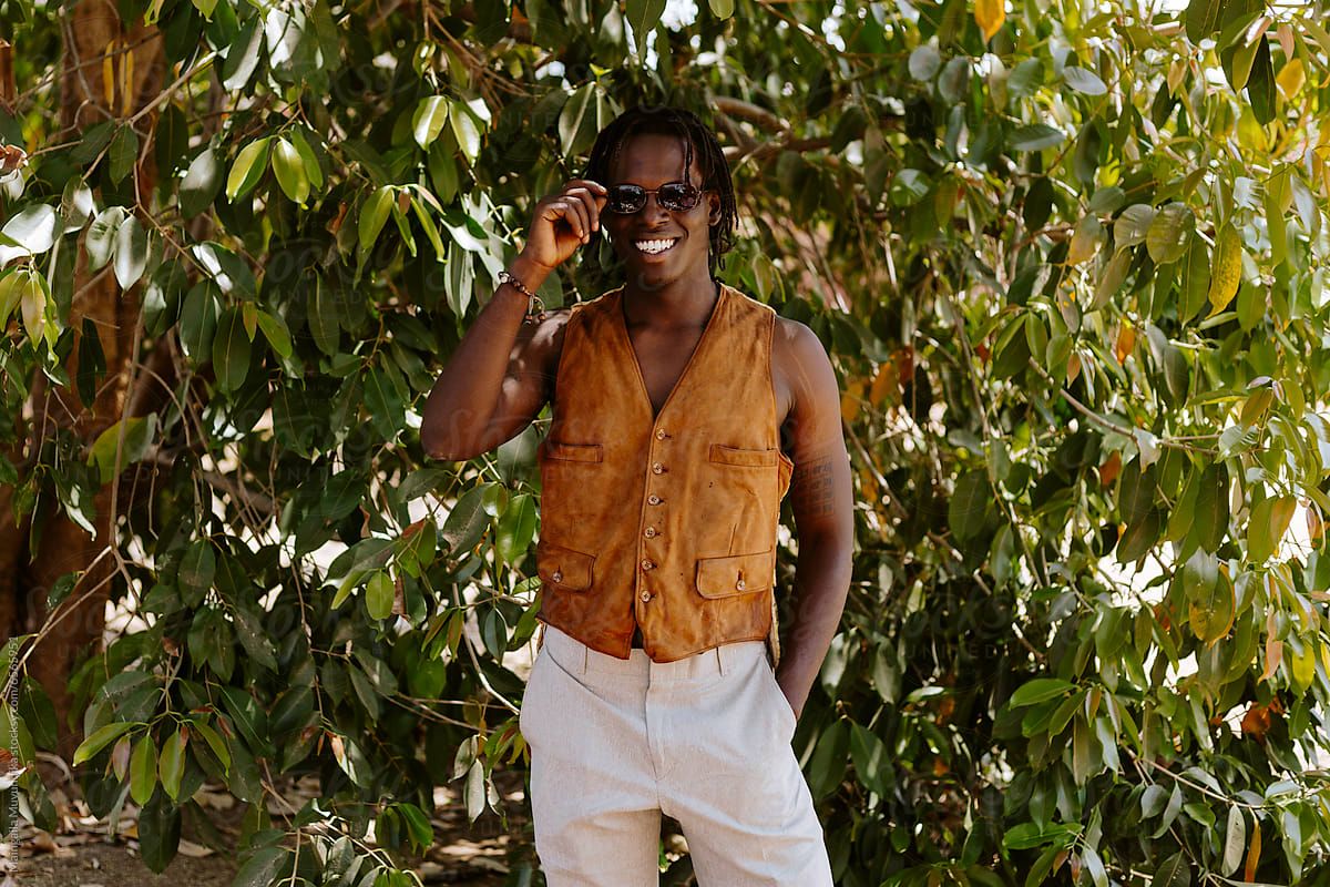 "Young Black Man Standing In Front Of A Bush" by Stocksy Contributor ...