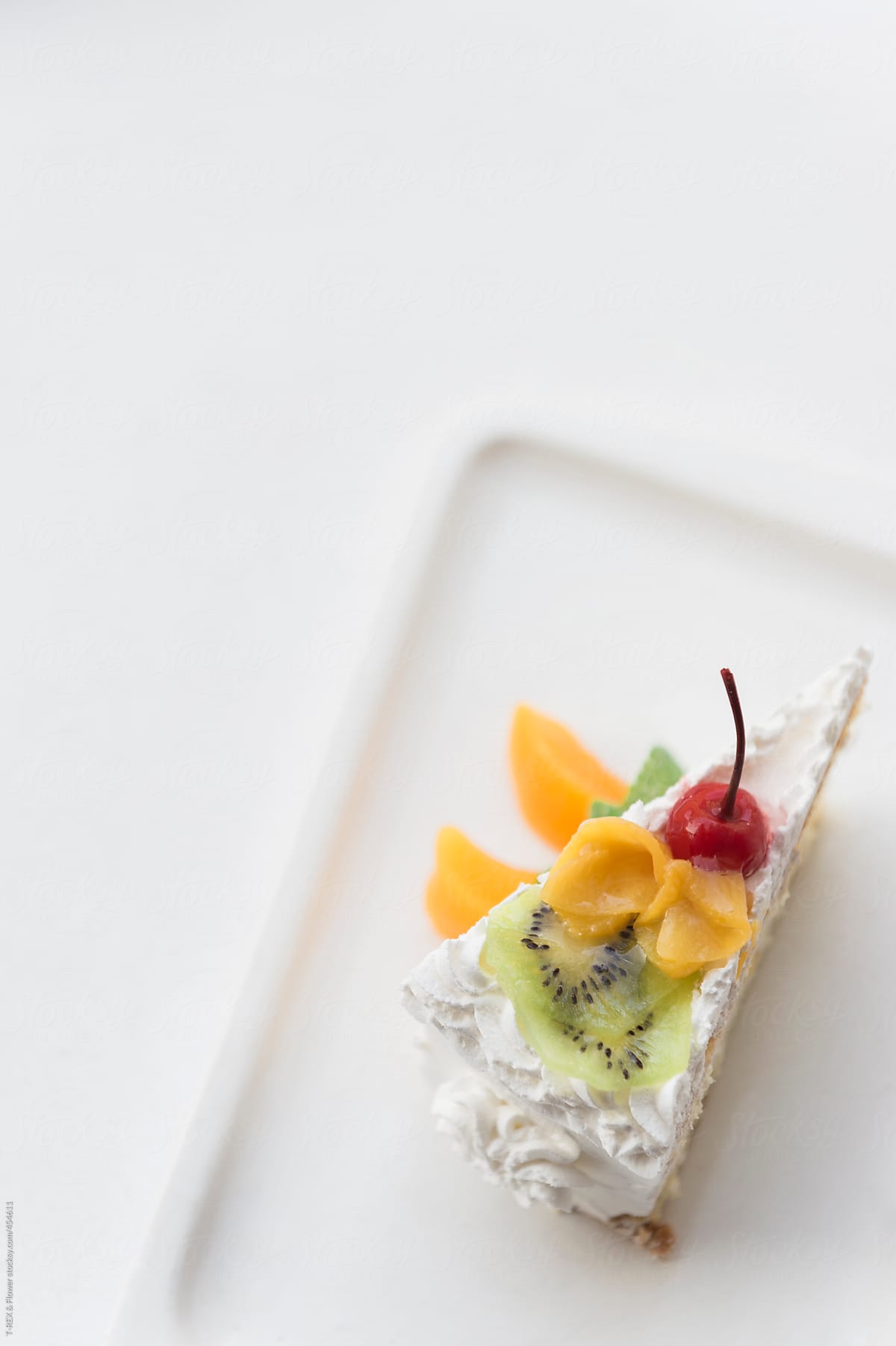 "Fruit Cake On White Plate" by Stocksy Contributor "Danil Nevsky" - Stocksy
