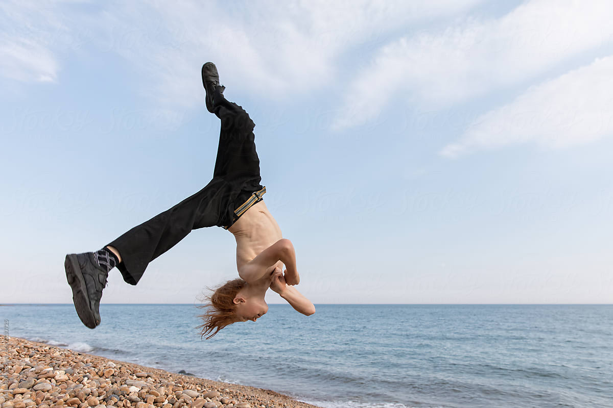 "A Young Boy Performs A Rolling Flip By The Sea" by Stocksy Contributor ...