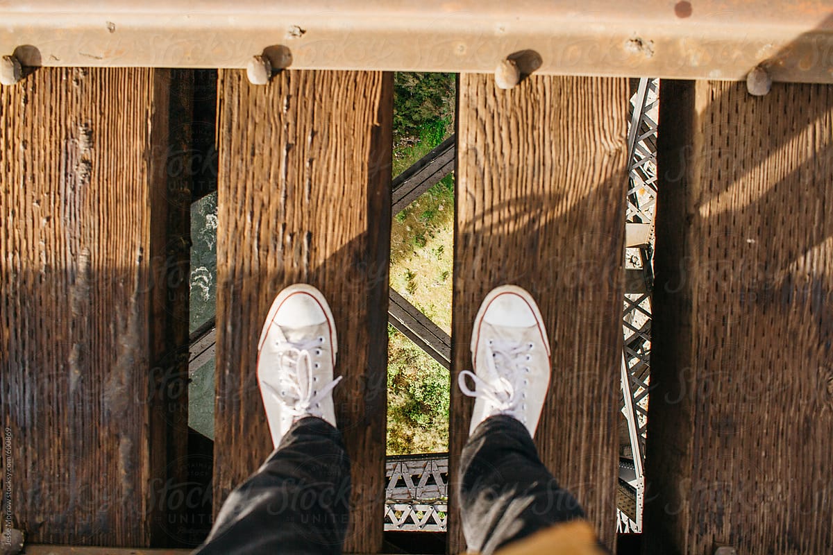 "Young Man Looking Down At Feet On Rail Road Track Bridge" by Stocksy ...