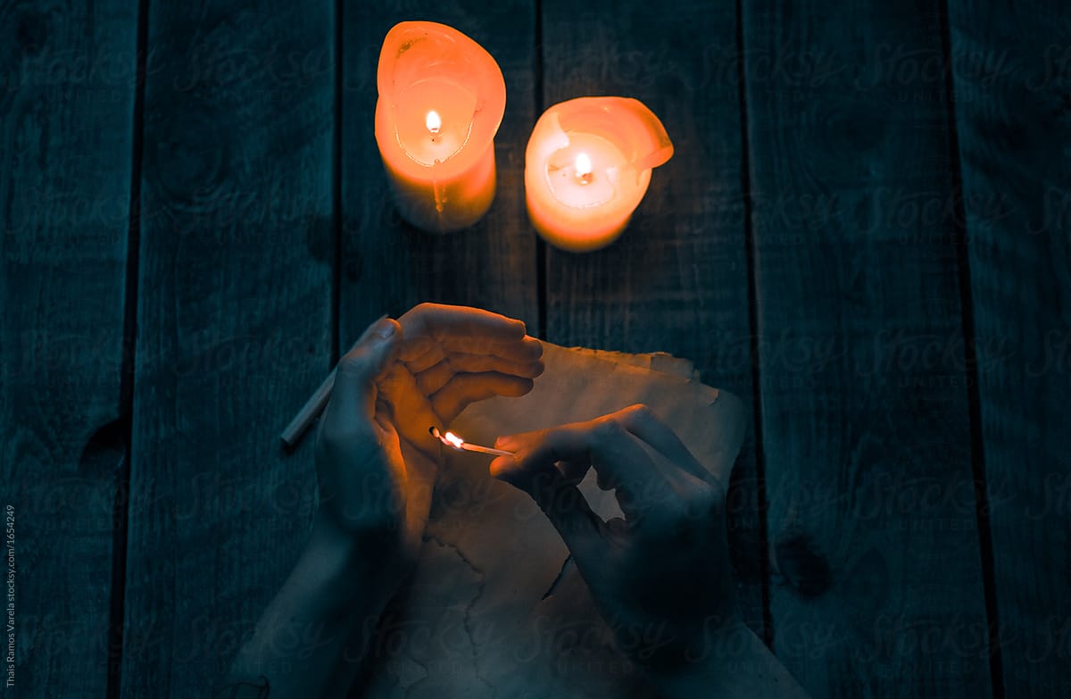 "Woman Lights A Match To Light A Candle" by Stocksy Contributor "THAIS ...