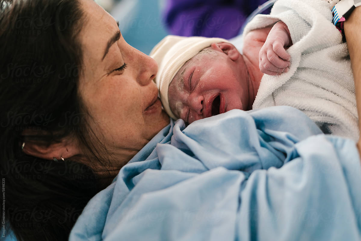 "Happy Mother Hugging Newborn Baby After Birth" by Stocksy Contributor ...