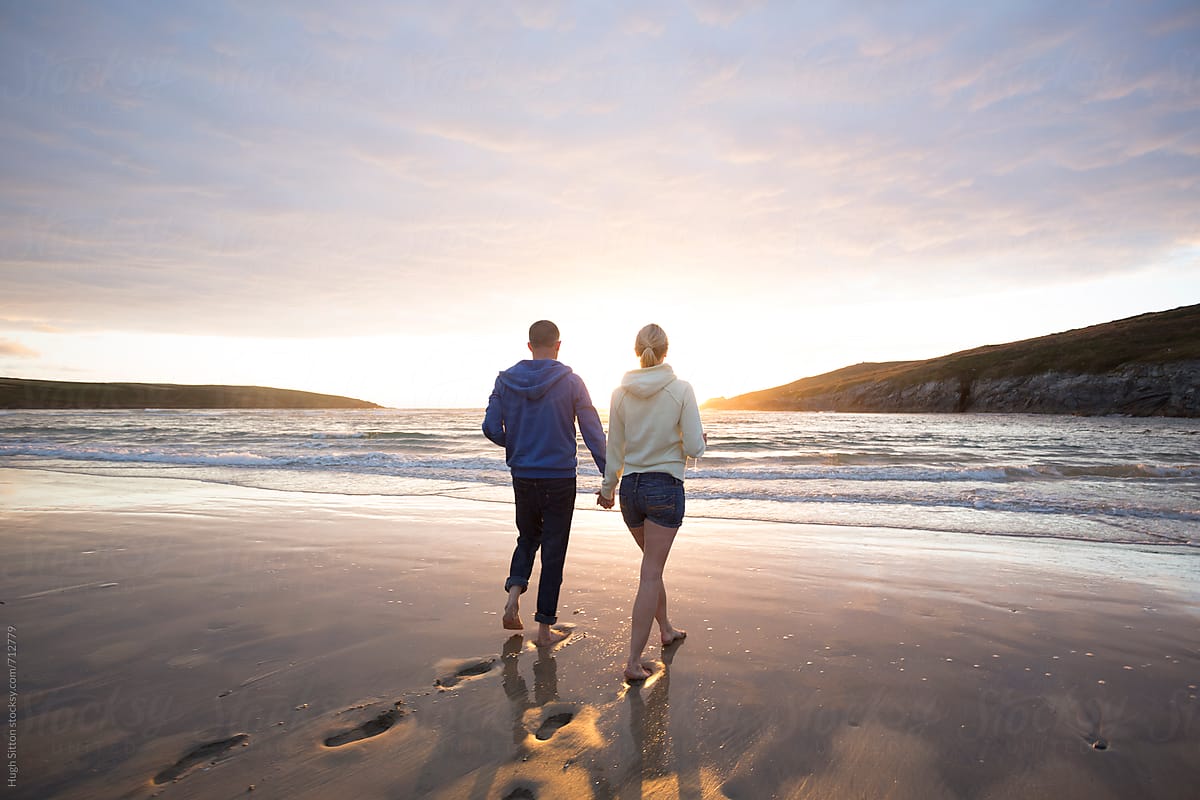 "Couple On Beach At Sunset." by Stocksy Contributor "Hugh Sitton" - Stocksy