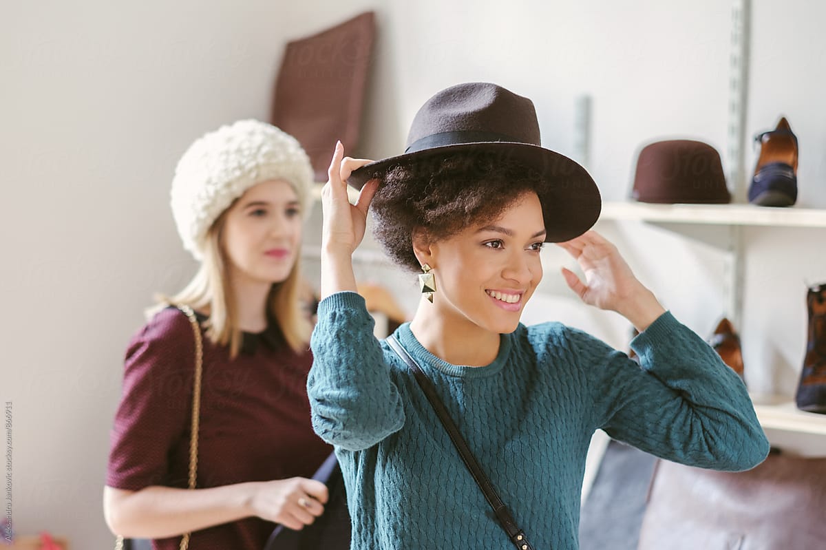 "Two Female Friends Shoppping Hats Together In The Store" by Stocksy ...