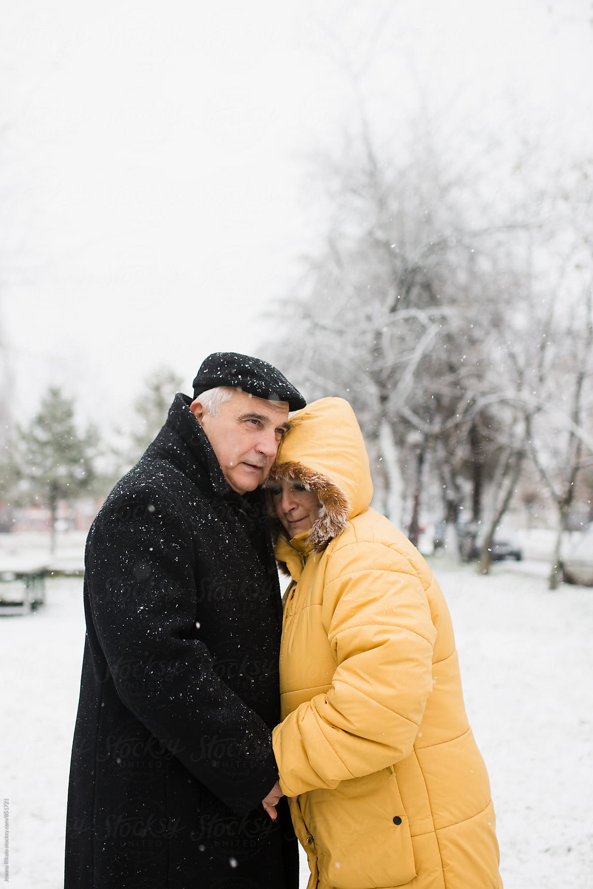 "Old Couple Hugging Outdoors In Snowfall" by Stocksy Contributor ...