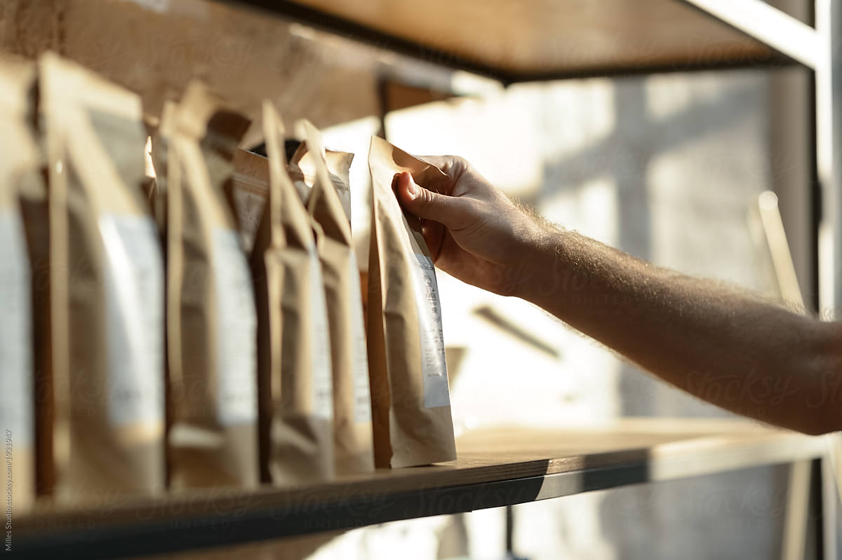 "Crop Man Setting Coffee Packs On Shelf" by Stocksy Contributor "Milles ...