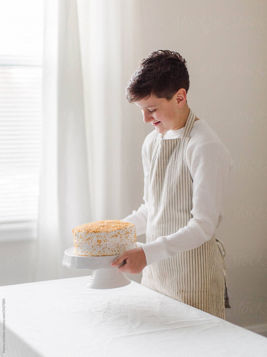 "Boy Serving A Cake" by Stocksy Contributor "Marta Locklear" - Stocksy