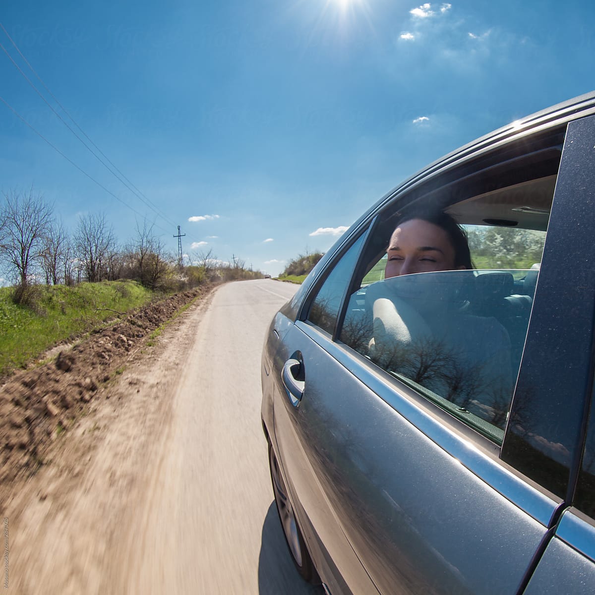 "Woman Enjoying Car Ride." by Stocksy Contributor "Mosuno" - Stocksy