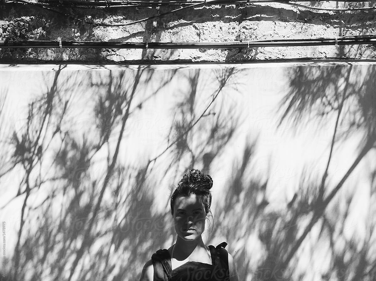 A beautiful woman in a tree shadow - Stock Image - Everypixel