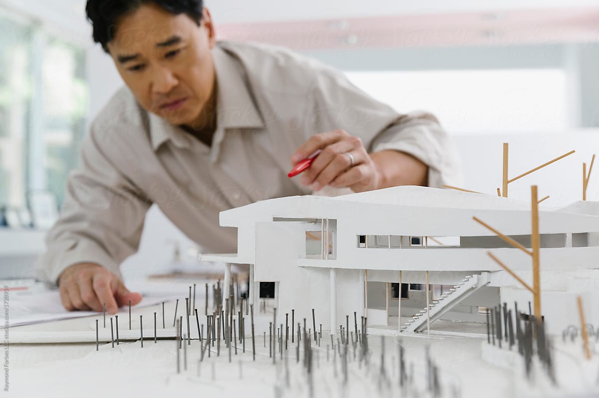 "Architect Working In Office" by Stocksy Contributor "Raymond Forbes ...