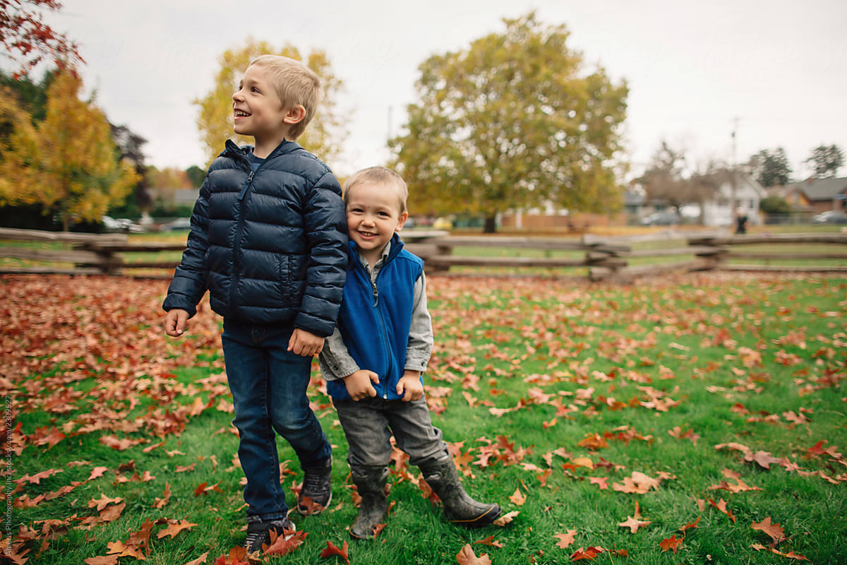 "Laughing Kids Outside In Fall Leaves" by Stocksy Contributor "Rob And ...